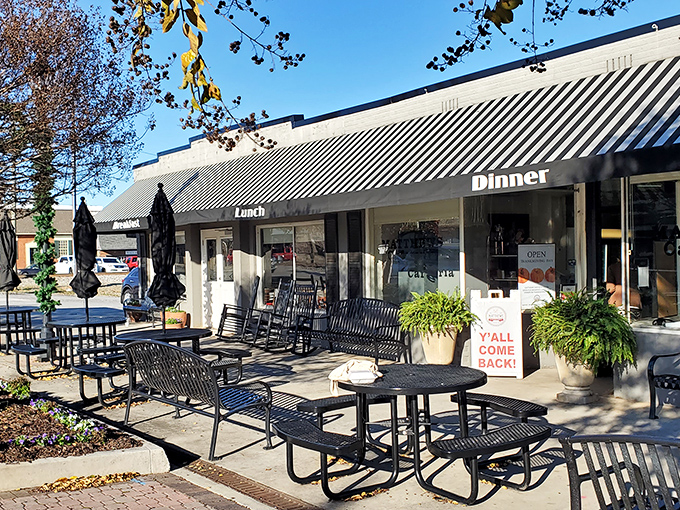 The classic striped awning of Matthews Cafeteria stands like a beacon of comfort food, promising Southern delights within these unassuming walls. 