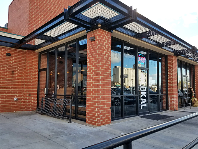 The unassuming brick exterior of The Lokal belies the culinary treasures within. Those two cypress trees stand like sentinels guarding Oklahoma's best-kept secret.