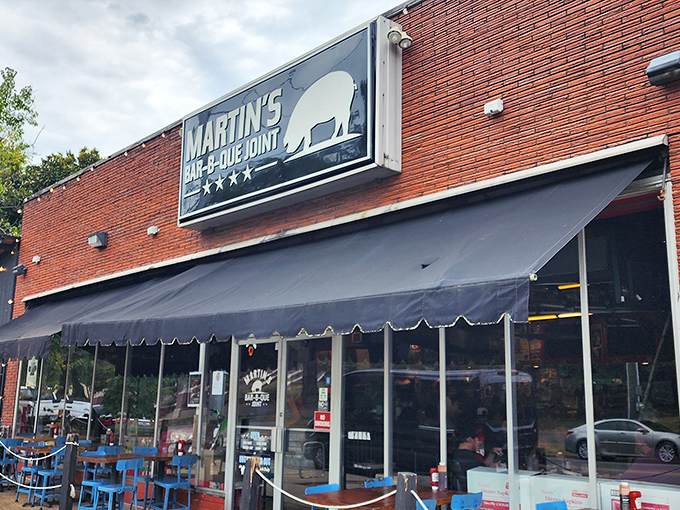 The red brick exterior of Martin's Bar-B-Que Joint beckons hungry pilgrims with its no-nonsense fa&ccedil;ade and the promise of smoky delights within.