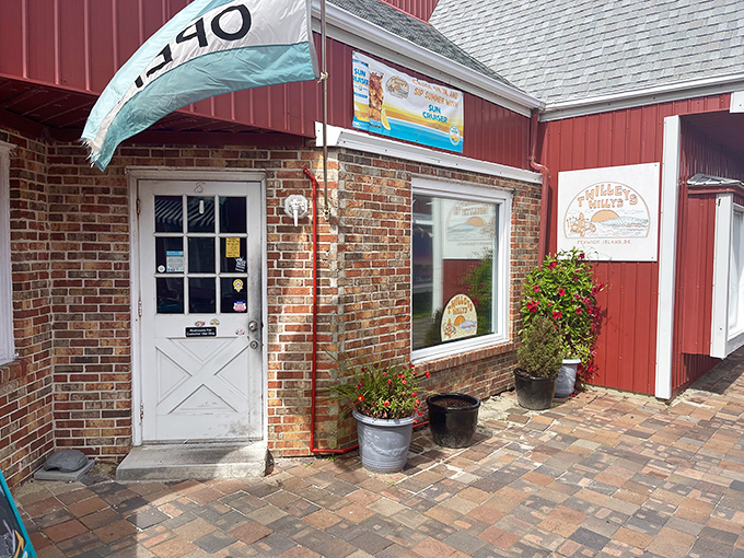 The iconic red barn exterior of Twilley's Willys stands like a beacon of hot dog hope against the Delaware sky, promising delicious adventures within.