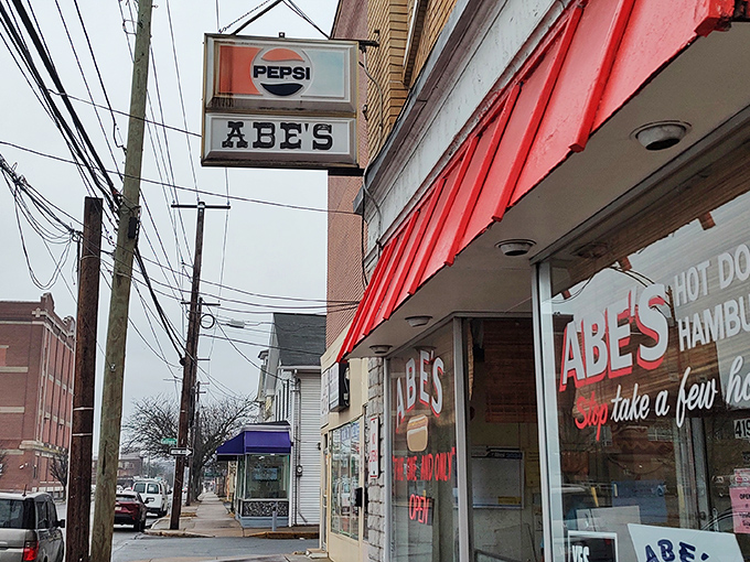 The classic American storefront that time forgot&mdash;complete with vintage sign, American flag, and the promise of comfort food that delivers on nostalgia. 