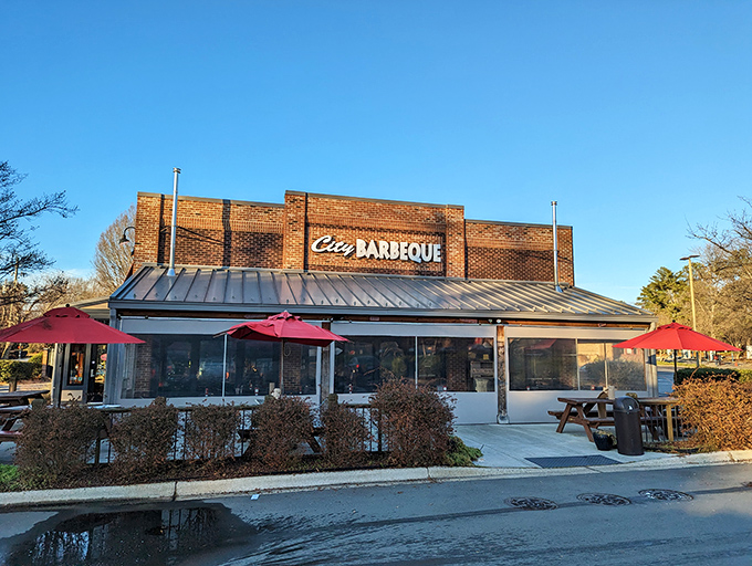 The brick fortress of flavor stands proud with its metal roof and welcoming red umbrellas&mdash;a barbecue beacon calling hungry travelers home. 