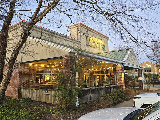 Izzy's welcomes hungry travelers with its distinctive green-trimmed roof and promise of brick oven delights&mdash;like finding a culinary oasis in Little Rock.