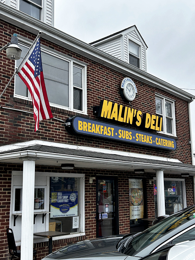 The brick facade of Malin's Deli stands as a beacon of sandwich salvation in Newark, promising subs, steaks, breakfast, and catering to hungry Delaware residents.