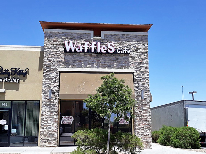 The stone facade of Waffles Cafe stands like a humble temple to breakfast, promising griddle-based salvation away from the neon chaos of the Strip.