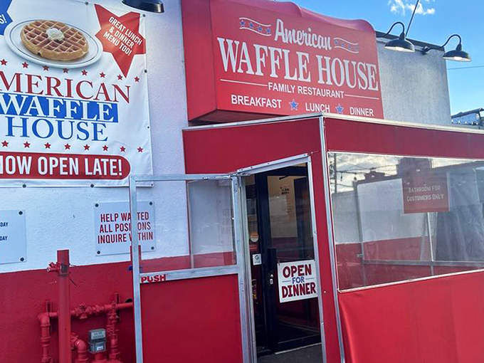 The bright red exterior of American Waffle House stands like a beacon of breakfast hope on Merrick Road. Resistance is futile.