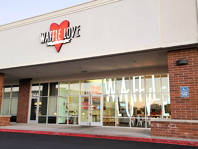 The bright red heart logo of Waffle Love beckons from the storefront like a siren song for breakfast enthusiasts. Your waffle journey begins here.