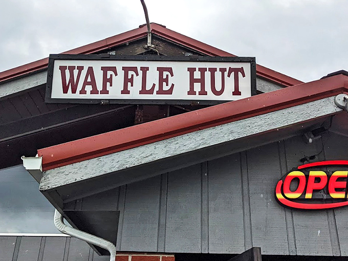 The modest sign says "WAFFLE HUT" but might as well read "Breakfast Paradise Ahead." Sometimes the most unassuming exteriors hide the greatest culinary treasures.