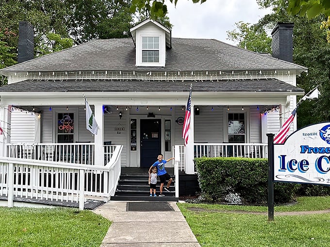 Home sweet ice cream home! This picture-perfect white farmhouse with its inviting porch practically whispers "slow down and treat yourself" to every passerby.