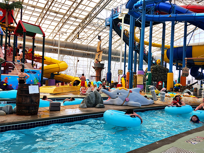 The indoor tropical paradise where winter goes to die. Colorful water structures and artificial palm trees create a mirage of summer under a cathedral of glass.