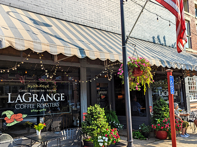 The classic storefront of La Grange Coffee Roasters beckons with its striped awning and hanging flower baskets, like a caffeine-fueled oasis on Main Street.