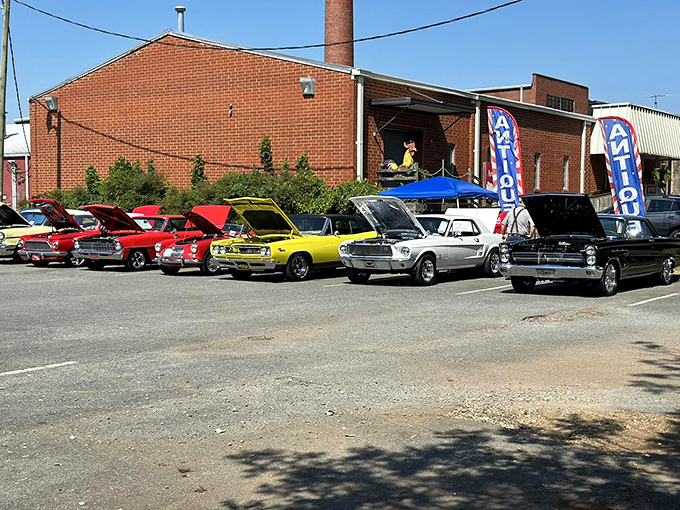 The unassuming brick fa&ccedil;ade with its vintage metal chairs and flamingo sentinel&mdash;proof that the best treasure maps often start with a simple "ANTIQUES" sign.