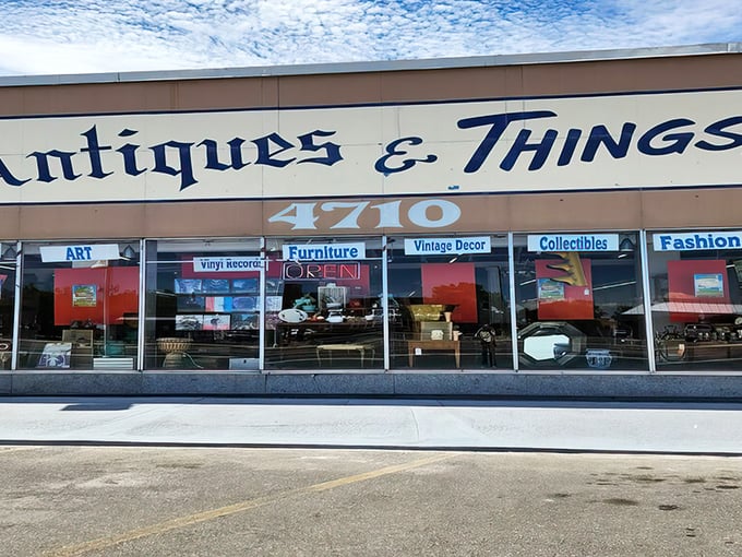 The storefront beckons with promises of treasures within, its blue lettering against beige like a desert sky invitation to explore.