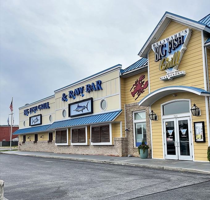 The cheerful yellow exterior with its signature blue roof stands like a maritime beacon, promising seafood treasures within Wilmington's revitalized Riverfront district. 