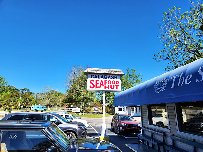 The iconic blue awning and simple sign of Calabash Seafood Hut stand as a beacon for seafood pilgrims. No fancy frills needed when the food speaks this loudly.
