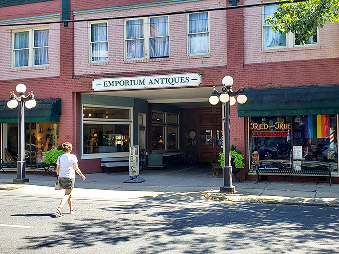 The brick facade of Emporium Antiques beckons like a time portal on Frederick's historic street. Vintage lampposts add that perfect nostalgic touch.