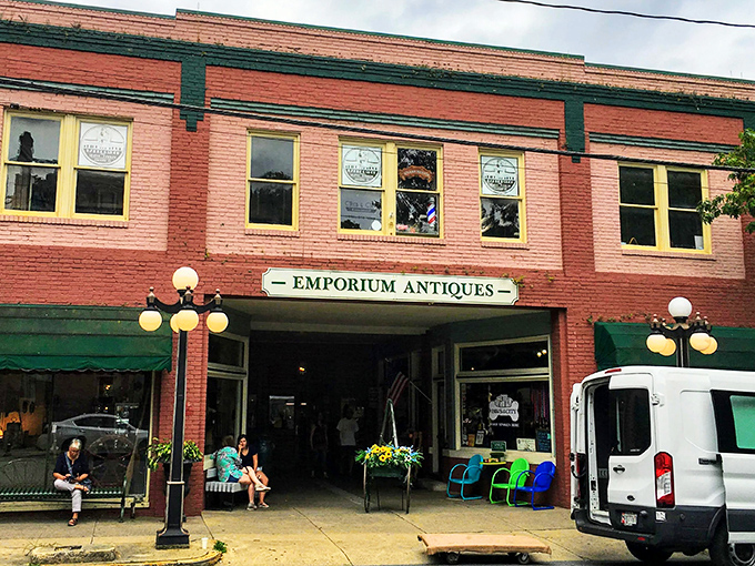 The brick facade of Emporium Antiques beckons like a time portal on Frederick's historic street. Vintage lampposts add that perfect nostalgic touch.