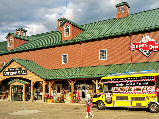 The rustic exterior of Berlin Village Antique Mall stands like a time portal in Ohio's Amish Country, promising treasures within its weathered wooden walls.