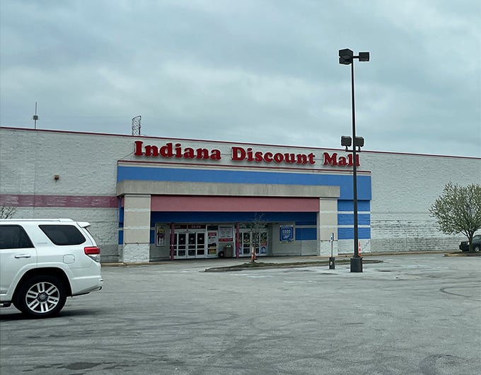 The red, white, and blue exterior serves as a retail lighthouse, guiding bargain hunters to shores where deals await and wallets breathe sighs of relief.