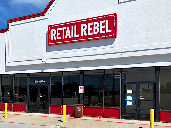 The red-trimmed fa&ccedil;ade of Retail Rebel stands like a beacon of bargain hope against the Missouri sky, promising treasures within for the deal-savvy shopper.