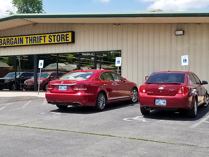 The unassuming exterior of Bargain Thrift Store stands like a vault of hidden treasures, its yellow sign a beacon to bargain hunters across Oklahoma City.