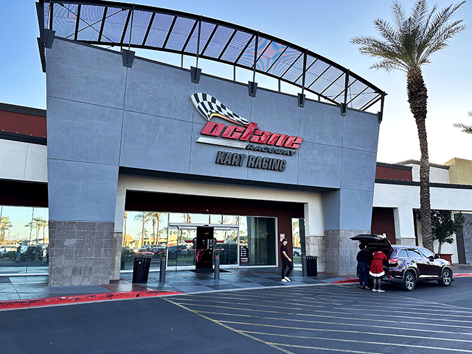 The entrance to Octane Raceway stands like a modern-day coliseum for speed demons, palm trees swaying as if applauding your imminent victory lap.