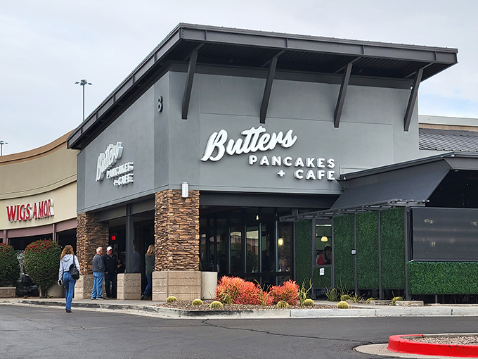 The stone-accented facade of Butters Pancakes & Cafe doesn't just welcome you—it practically issues a breakfast challenge to the line of eager patrons.