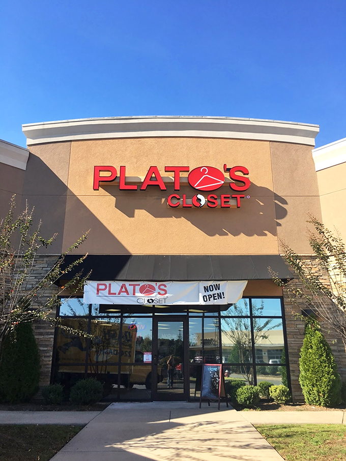The tan fa&ccedil;ade and bold red signage of Plato's Closet beckons like a fashion oasis in the suburban retail landscape.