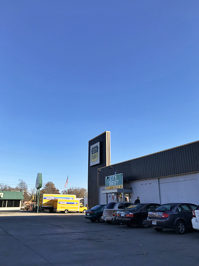 The iconic black and white exterior of City Thrift Waldo stands like a beacon for bargain hunters, complete with festive pennant flags that seem to whisper, "Treasures await inside!"