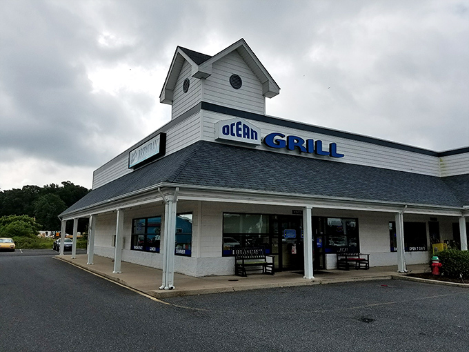 The white clapboard exterior of Ocean Grill stands like a beacon of comfort food promise. Those nautical round windows aren't just for show&mdash;they're portals to flavor town.