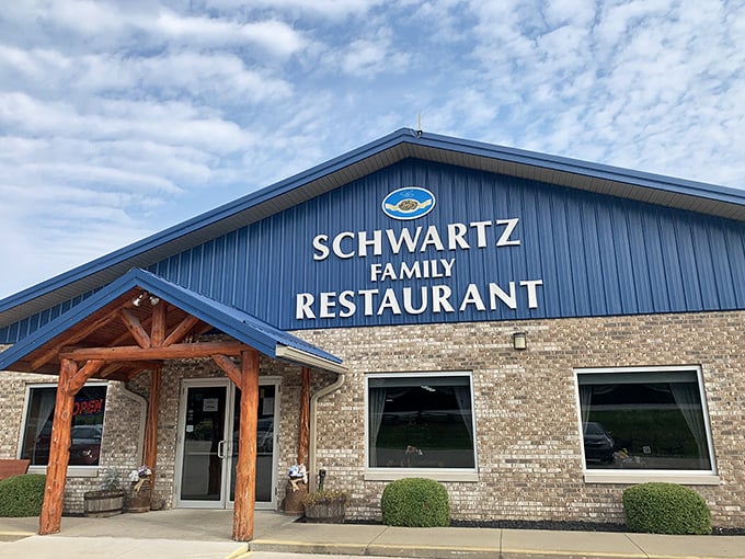 The blue-roofed haven of homestyle cooking stands proudly against an Indiana sky, promising comfort food that'll make your soul sing.