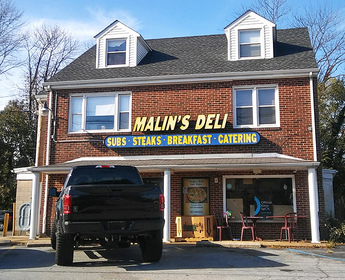 The unassuming brick facade of Malin's Deli stands like a sandwich sentinel in Newark, promising delicious treasures within for those wise enough to stop.