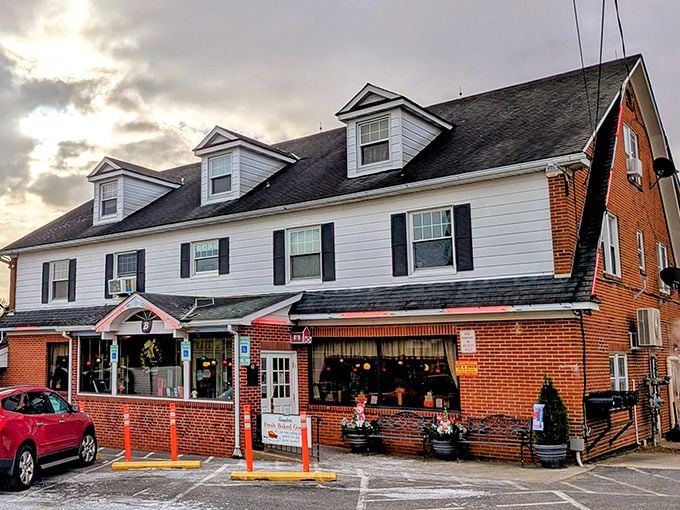 The classic white colonial exterior of Baugher's stands like a beacon of comfort food promise against Maryland's blue skies.