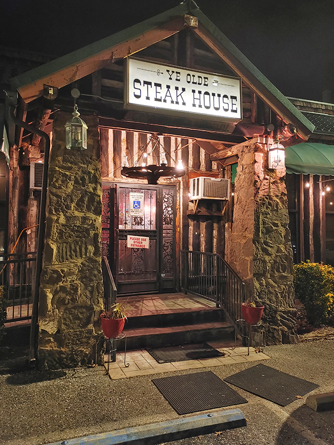 The stone facade and illuminated sign of Ye Olde Steak House beckons like a carnivore's lighthouse on a dark Tennessee night.