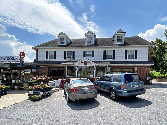 The classic white colonial exterior of Baugher's stands like a beacon of comfort food promise against Maryland's blue skies.