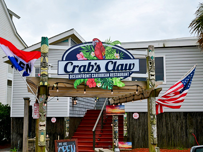The entrance to paradise isn't pearly gates, but red stairs flanked by tiki totems and colorful flags announcing your arrival at seafood heaven.