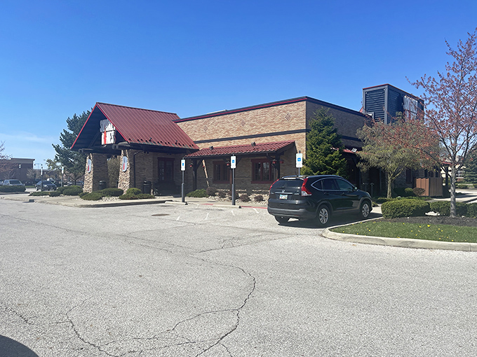 The barbecue beacon of Grove City stands ready to welcome hungry pilgrims with its rustic stone facade and signature red roof.