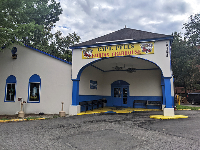 The blue and white exterior of Captain Pell's stands like a maritime beacon in suburban Fairfax, promising seafood treasures within. No pretension, just delicious anticipation.
