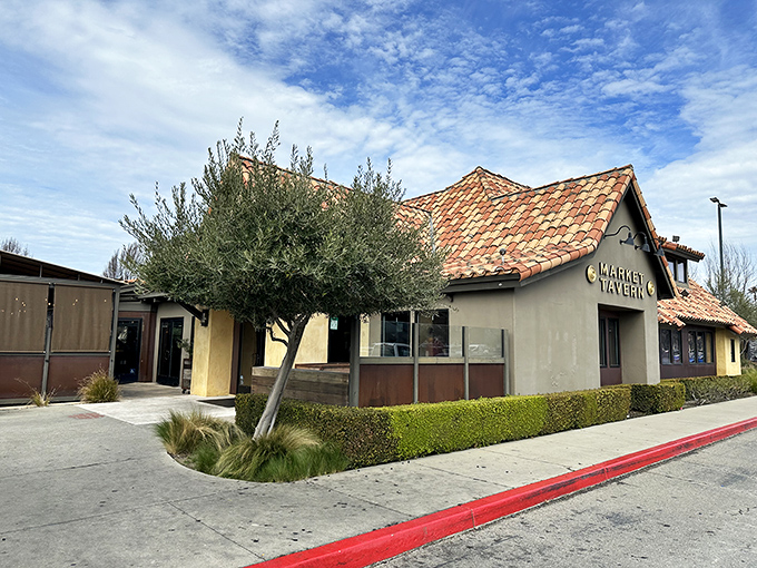 The Spanish-style terracotta roof and inviting facade of Market Tavern stands like a Mediterranean oasis in Dublin, California's suburban landscape.