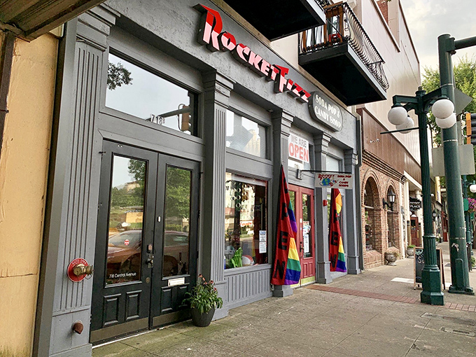 The storefront beckons like a portal to childhood, its bright red sign promising sweet revelations within Hot Springs' historic downtown district.