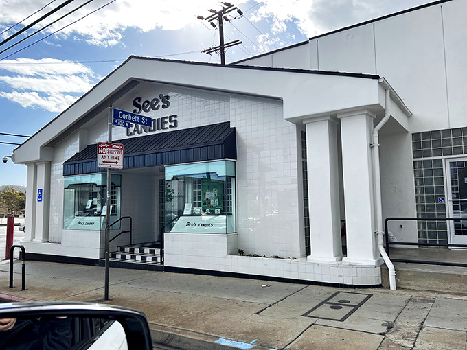 The iconic white building with black trim stands like a temple to sweetness, beckoning chocolate pilgrims with its timeless charm.