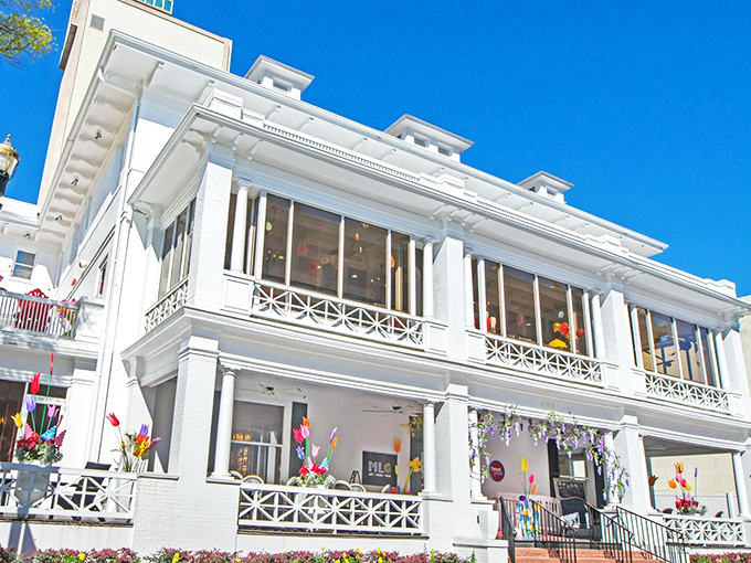 The grand white mansion housing Sweet Pete's stands like a sugar palace against Jacksonville's blue sky, promising sweet adventures within.