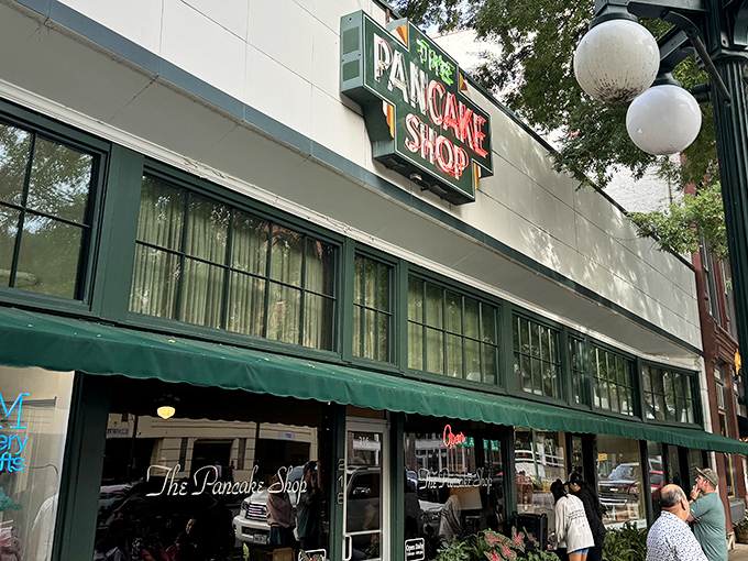 The iconic green sign beckons like a breakfast lighthouse on Central Avenue, promising pancake paradise to early risers and brunch enthusiasts alike.