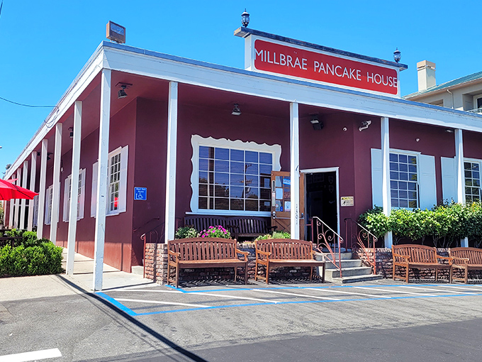 The iconic red sign beckons like a lighthouse for breakfast lovers. This unassuming burgundy building has launched a thousand food comas.