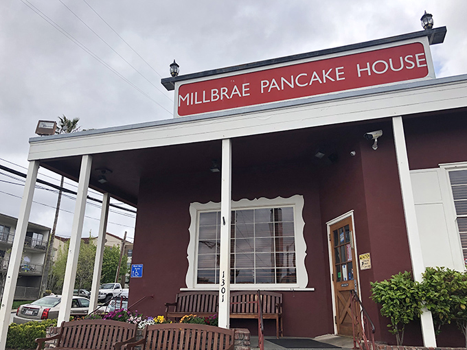 The iconic red sign beckons like a lighthouse for breakfast lovers. This unassuming burgundy building has launched a thousand food comas.