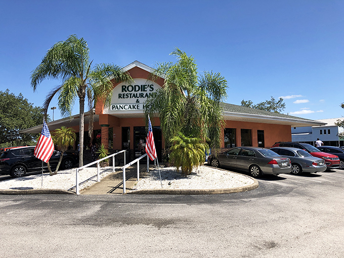 Sunshine, palm trees, and pancakes &ndash; Rodie's exterior promises Florida charm with its welcoming entrance and twin American flags fluttering in the Gulf breeze.