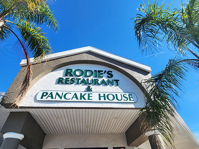 Sunshine, palm trees, and pancakes &ndash; Rodie's exterior promises Florida charm with its welcoming entrance and twin American flags fluttering in the Gulf breeze.