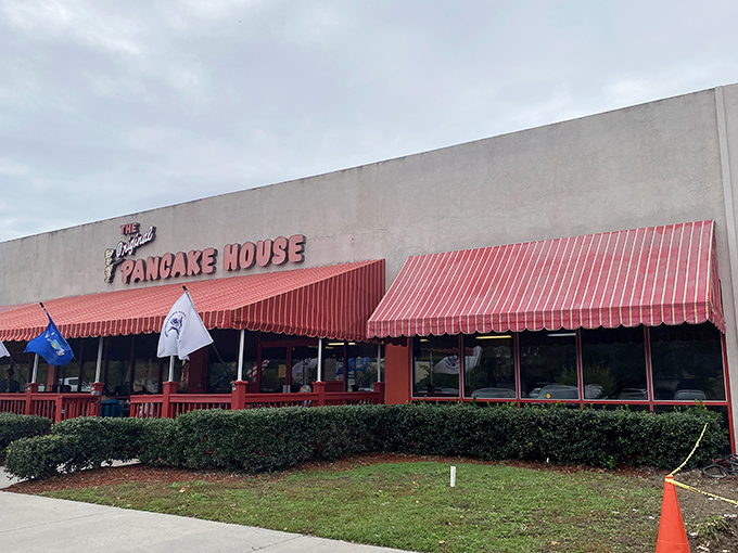 The iconic red awning beckons breakfast enthusiasts like a pancake lighthouse on the shores of morning hunger. A sight for sore, sleepy eyes!
