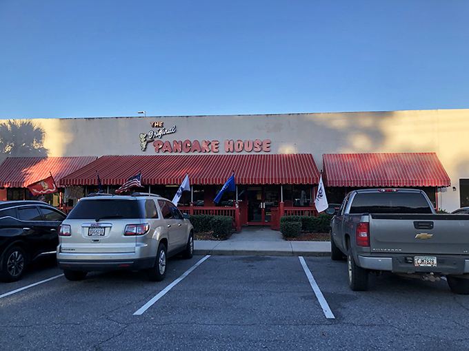 The iconic red awning beckons breakfast enthusiasts like a pancake lighthouse on the shores of morning hunger. A sight for sore, sleepy eyes!