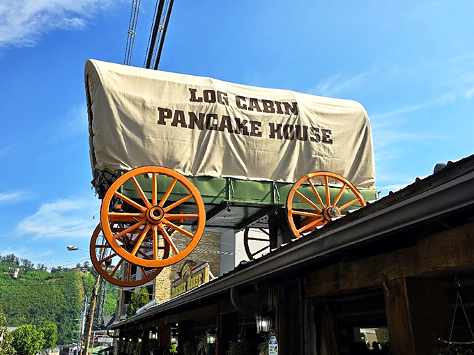 The iconic covered wagon sign welcomes hungry travelers like a beacon of breakfast hope on Gatlinburg's bustling parkway.